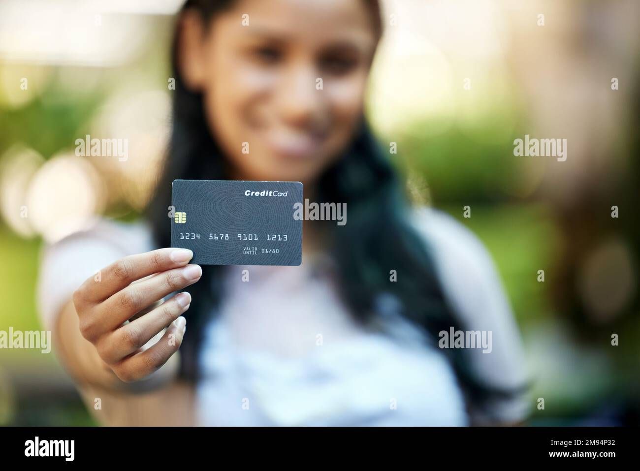 Were getting paid. a young business owner holding a credit card Stock ...