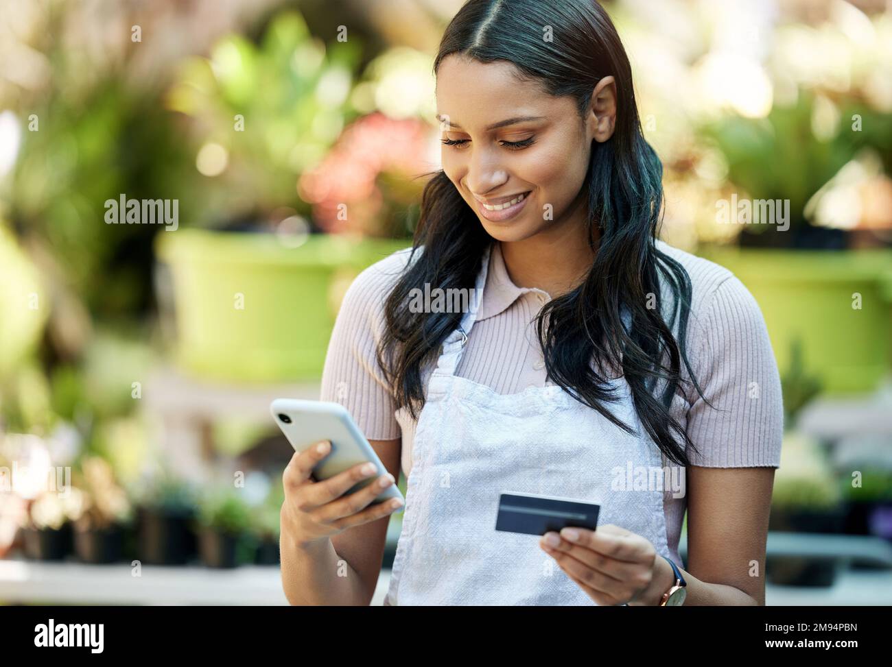 Theres no stopping her now. a young business owner using a cellphone ...
