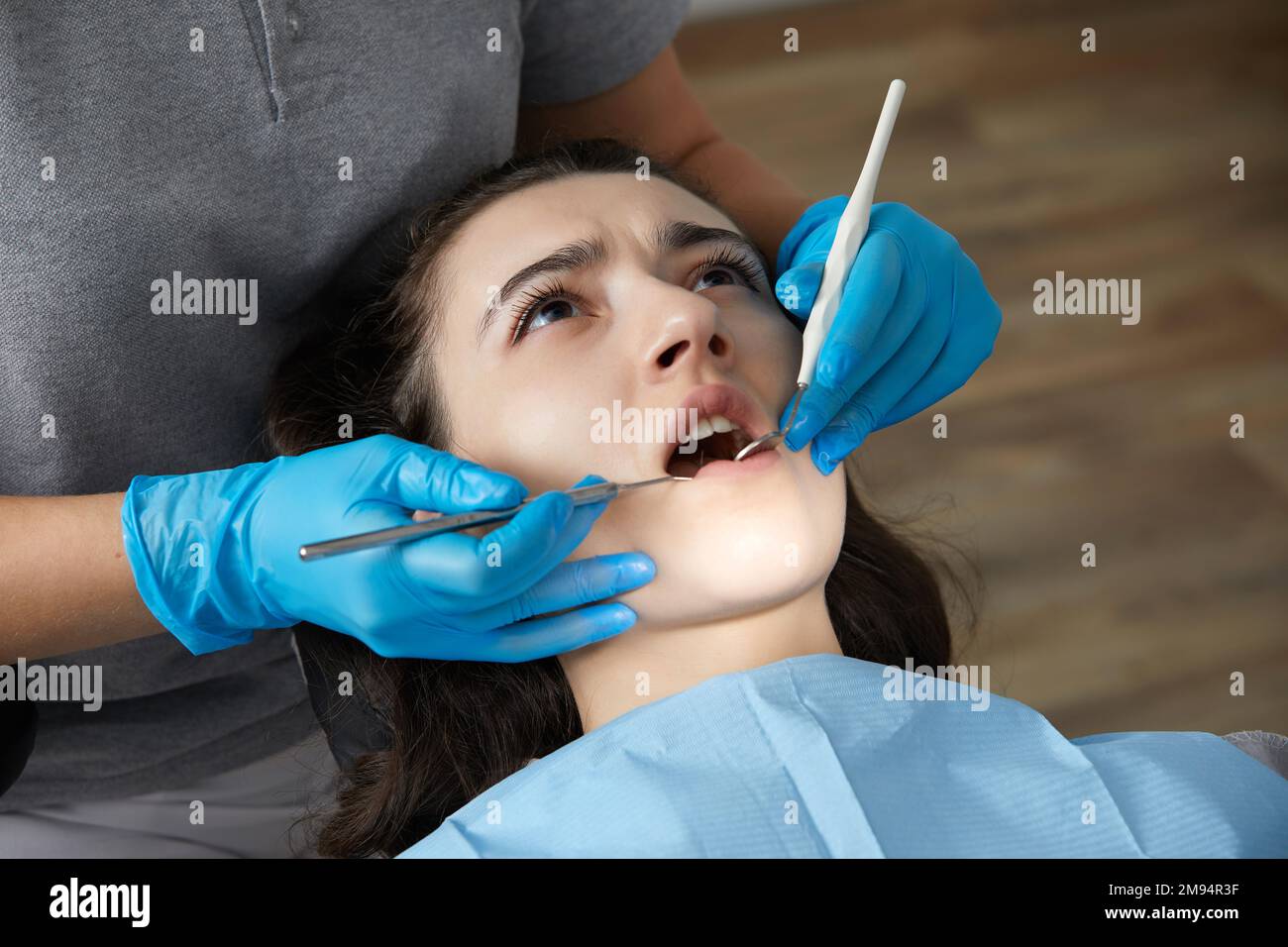 Dentist checking teeth of a female patient with dental mirror Stock ...