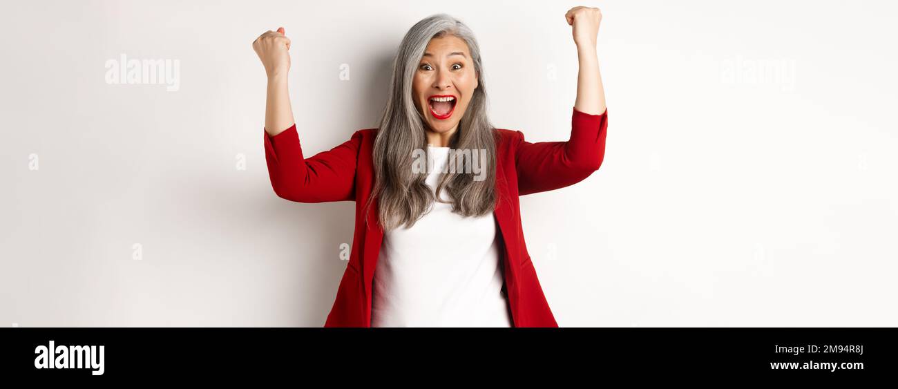 Lucky senior woman achieve success, winning prize and celebrating ...