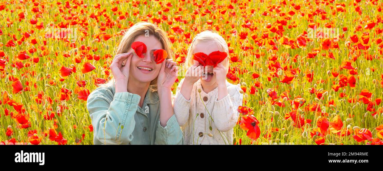 Mother and daughter on the poppies field background. Spring family ...