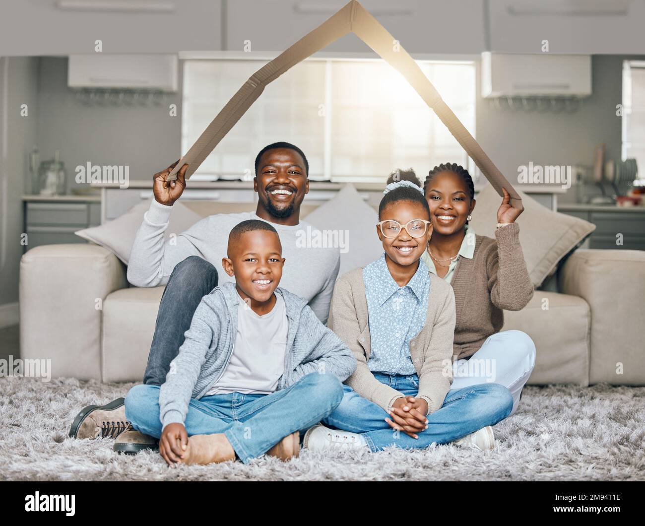 Grateful to have a roof over our heads. a young family relaxing together at home Stock Photo - Alamy