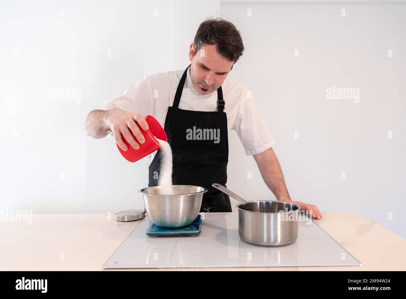 Hands of a man cooking a red velvet cake at home, preparing Swiss ...