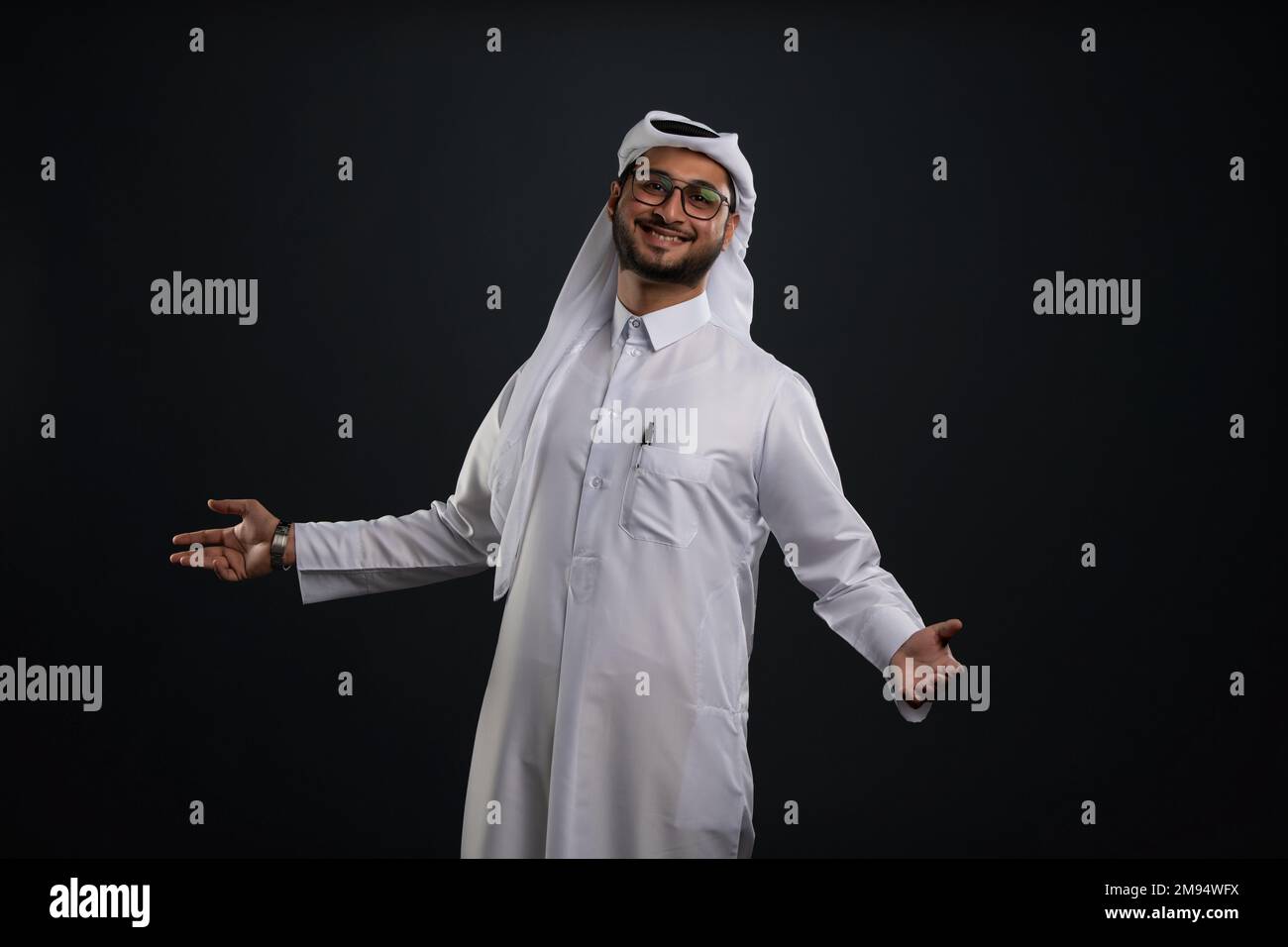 Arab Qatari Man using tablate and posing on isolated background. Male ...