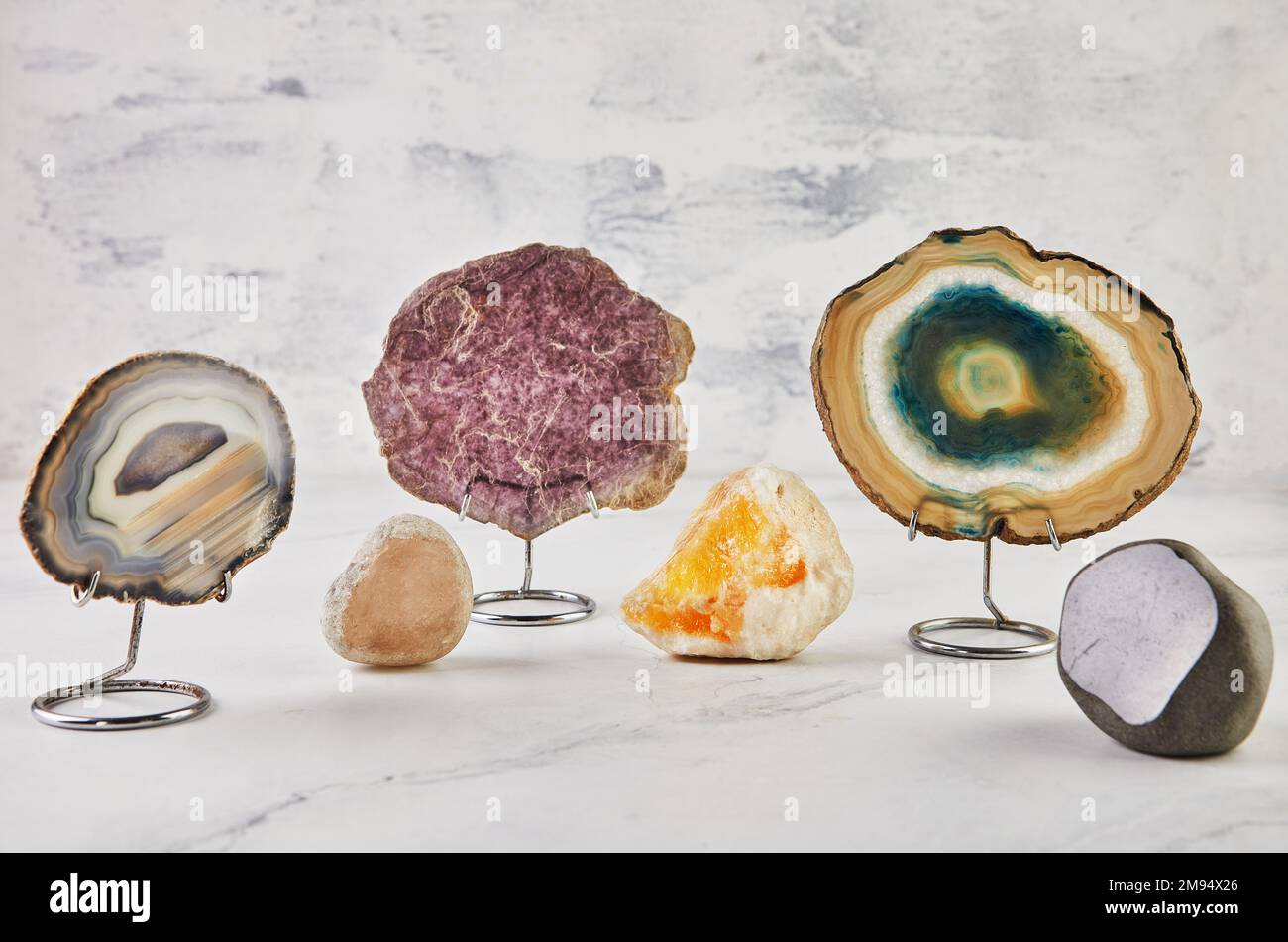 Collection of semi-precious stones of different colors and patterns on ...