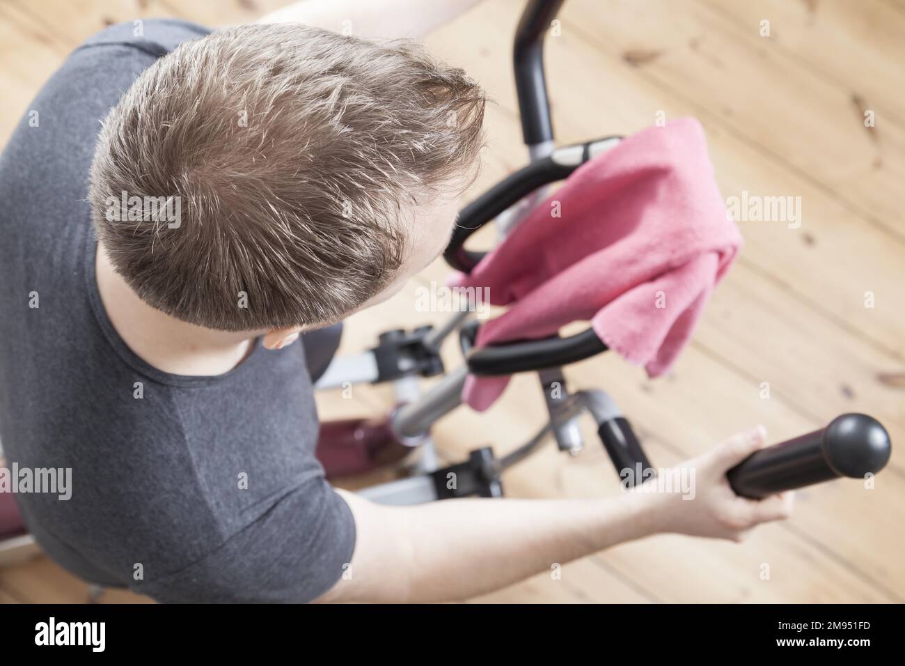 Man on the cross trainer, top view Stock Photo - Alamy