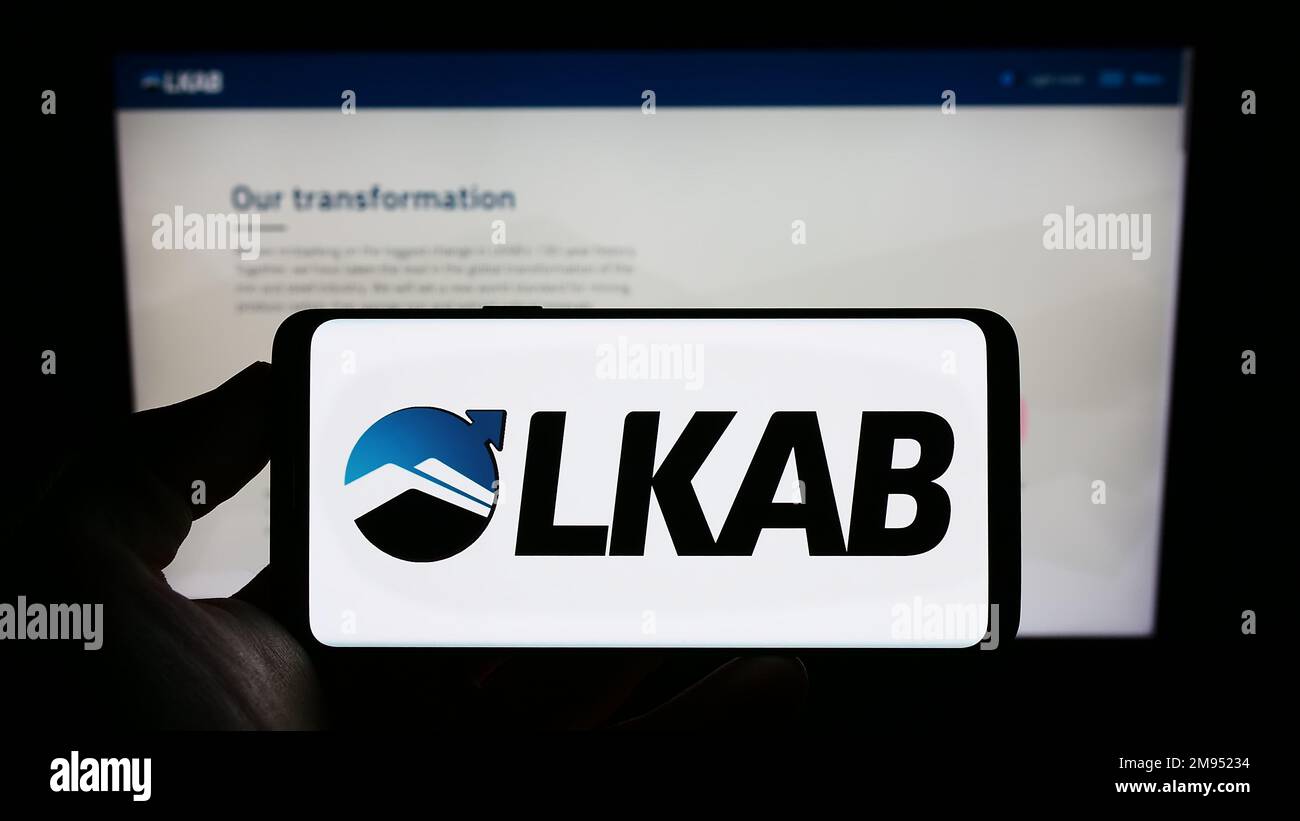 Person holding smartphone with logo of company Luossavaara-Kiirunavaara ...