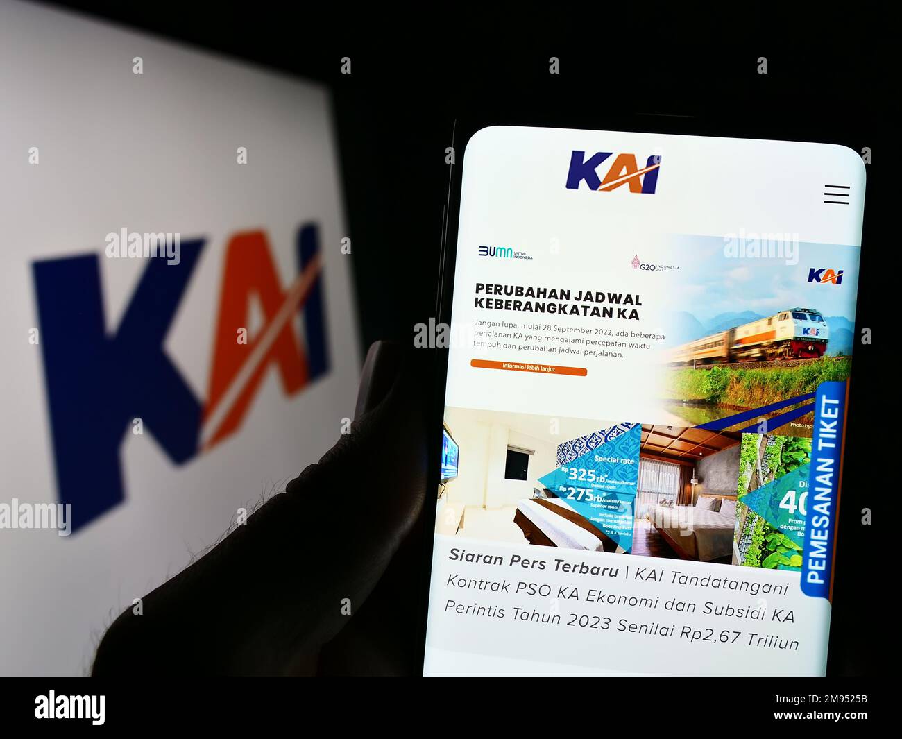 Person holding smartphone with website of Indonesian company PT Kereta ...