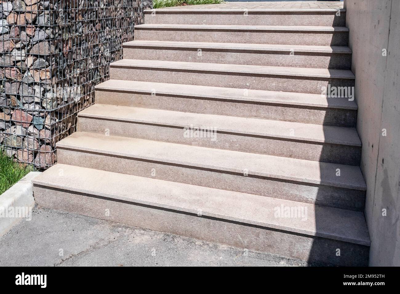 Stone staircase with massive steps made of polished stone slabs in a ...