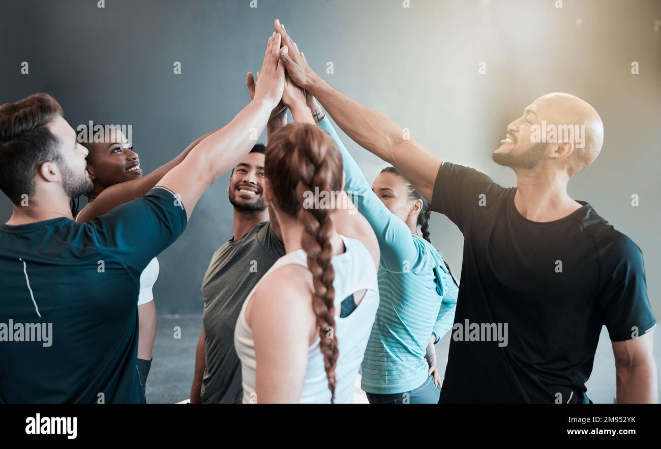 No better time than the present. a group of friends high fiving one ...