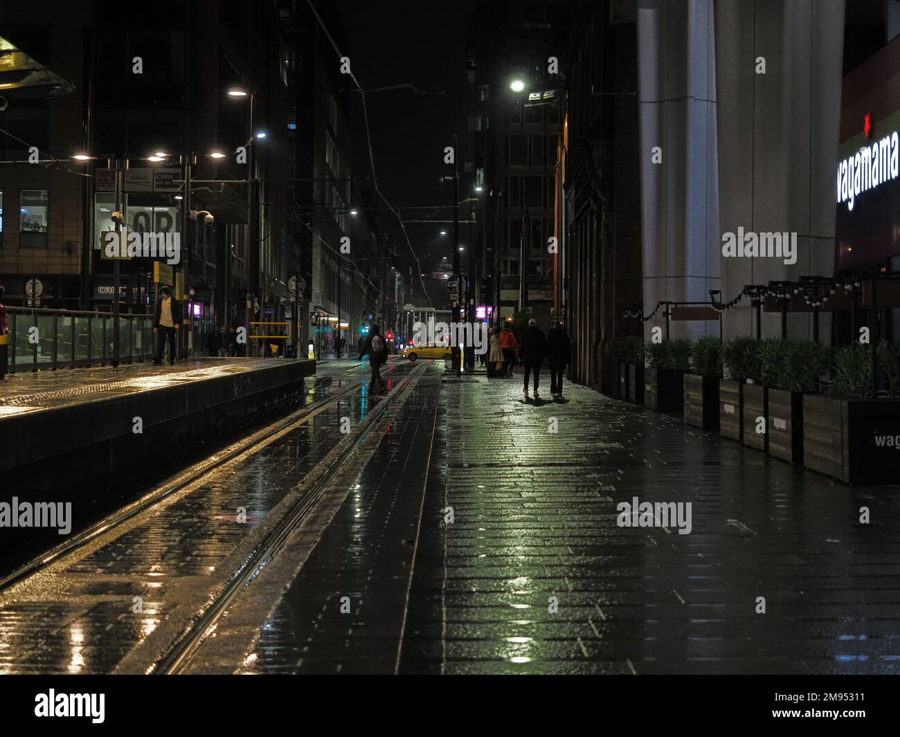 A rainy street surrounded by buildings in Manchester Stock Photo - Alamy