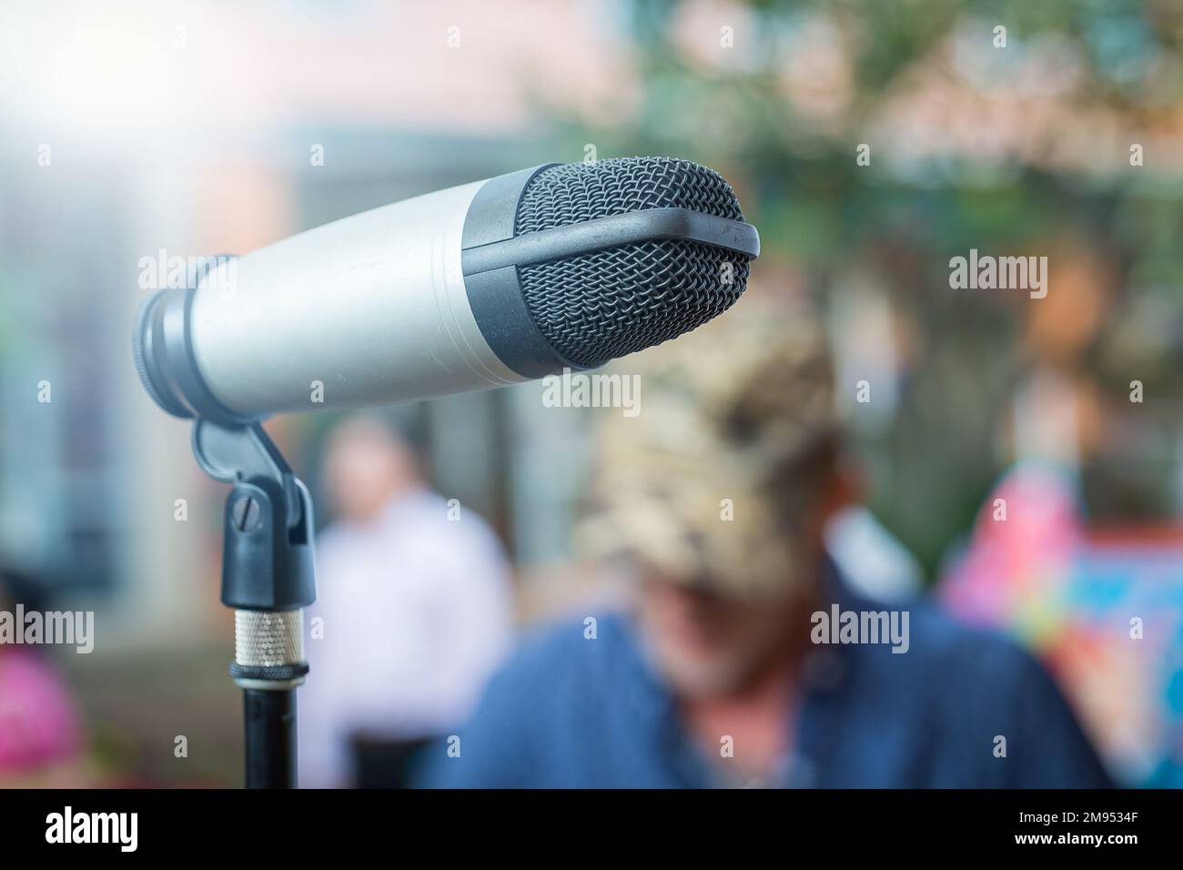 Close up of microphone in public place with blur background Stock Photo ...