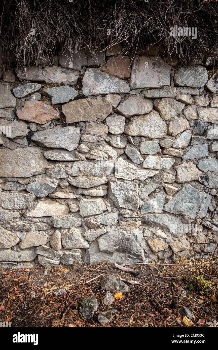 Old stone wall background with dry grass, vertical background Stock ...