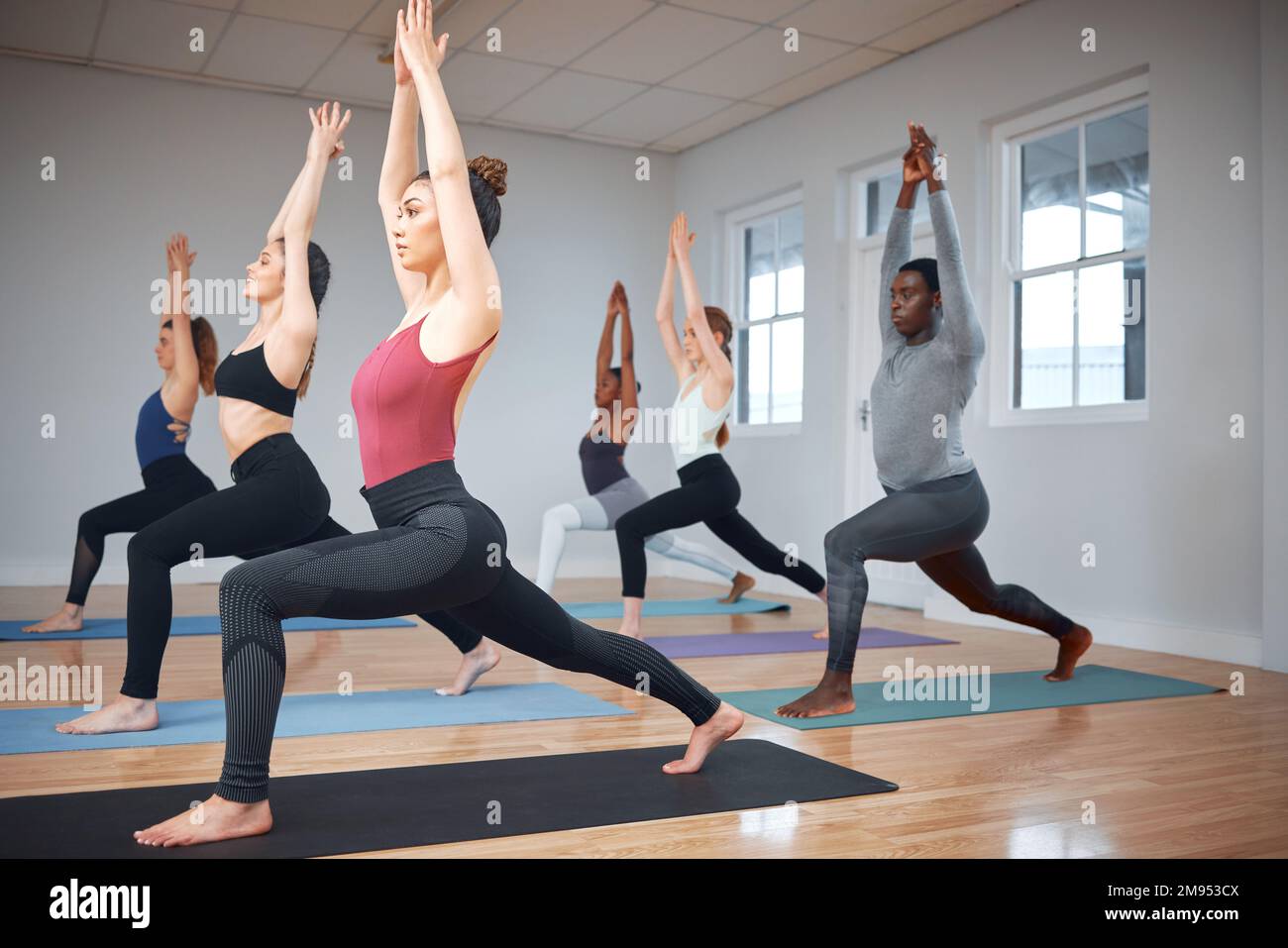 Extend those arms and lengthen your core. a group of yoga students ...
