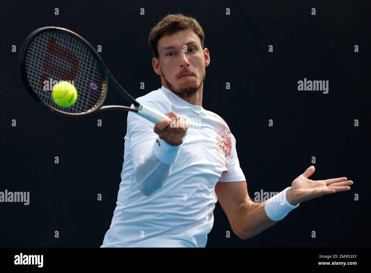 Pablo Carreno Busta of Spain plays a forehand return to Pedro Cachin of ...