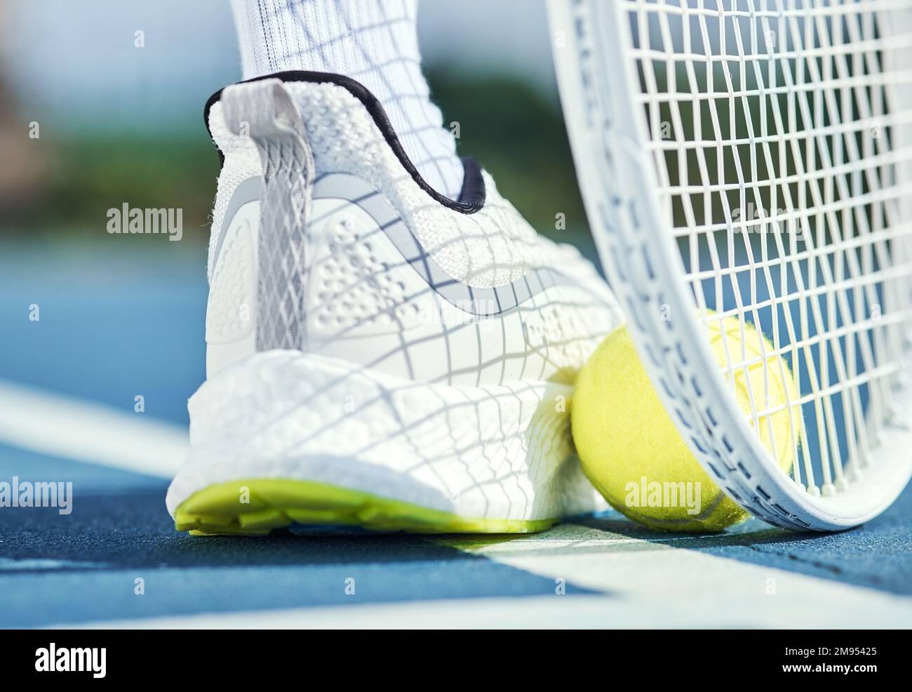 This is the only way to pick up a tennis ball. an unrecognisable man ...