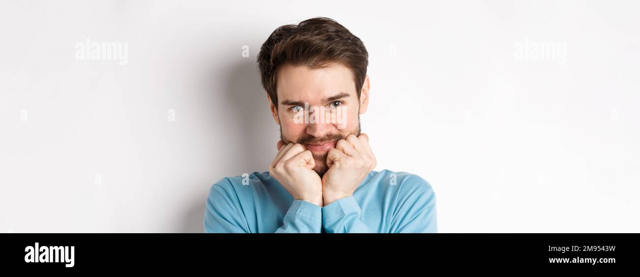 Cute caucasian man looking at something with admiration and desire ...