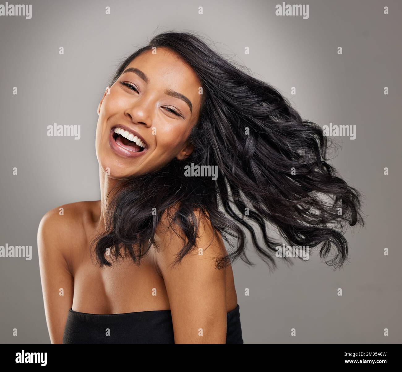 This hair was made for flipping. a beautiful young woman posing against ...