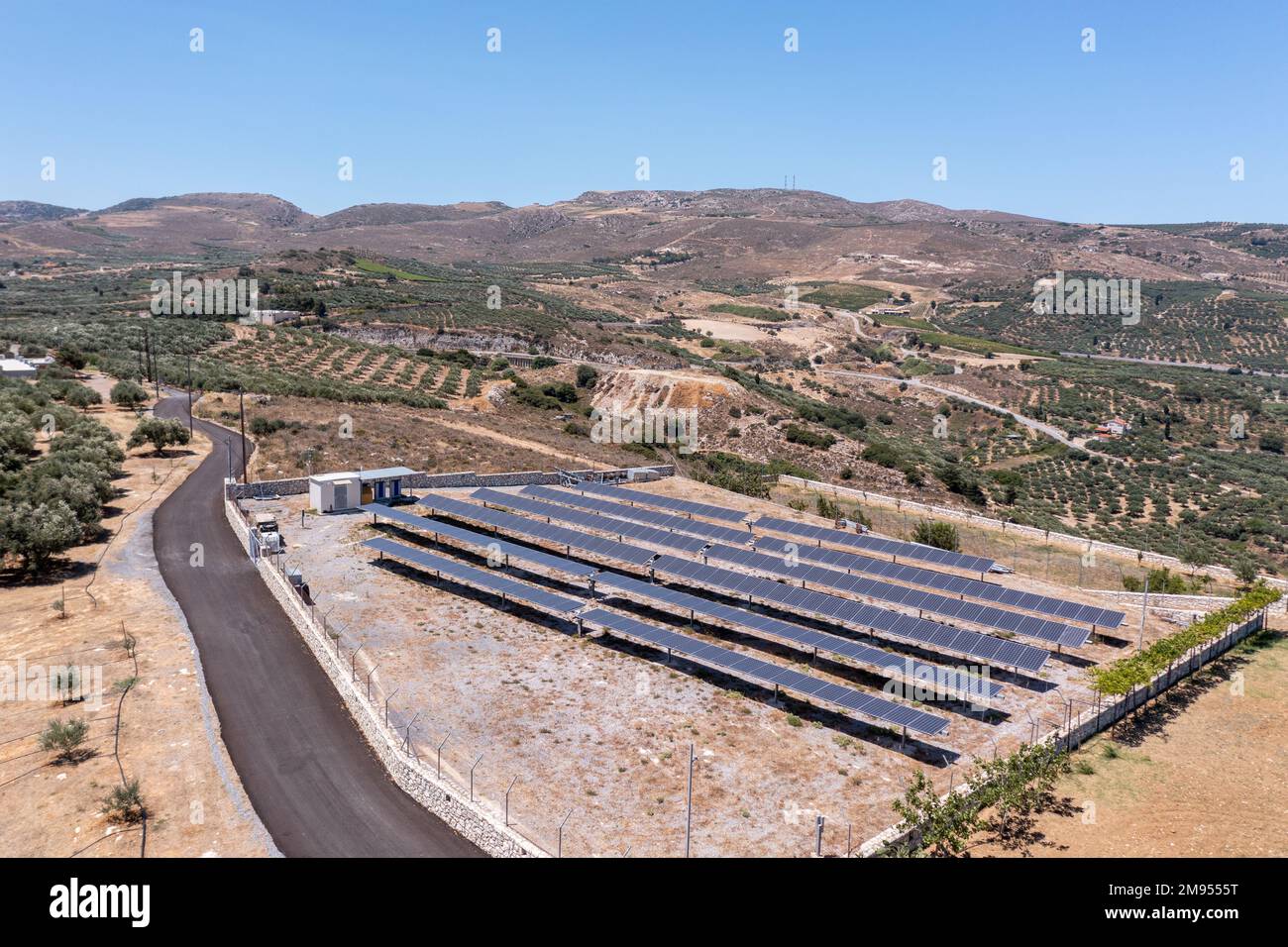 An aerial view of an open field filled with solar panels to generate ...