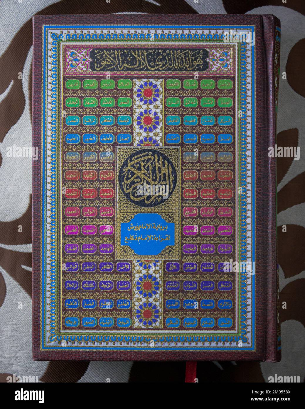 A top view of the Islamic holy book of the Quran placed on a cloth ...