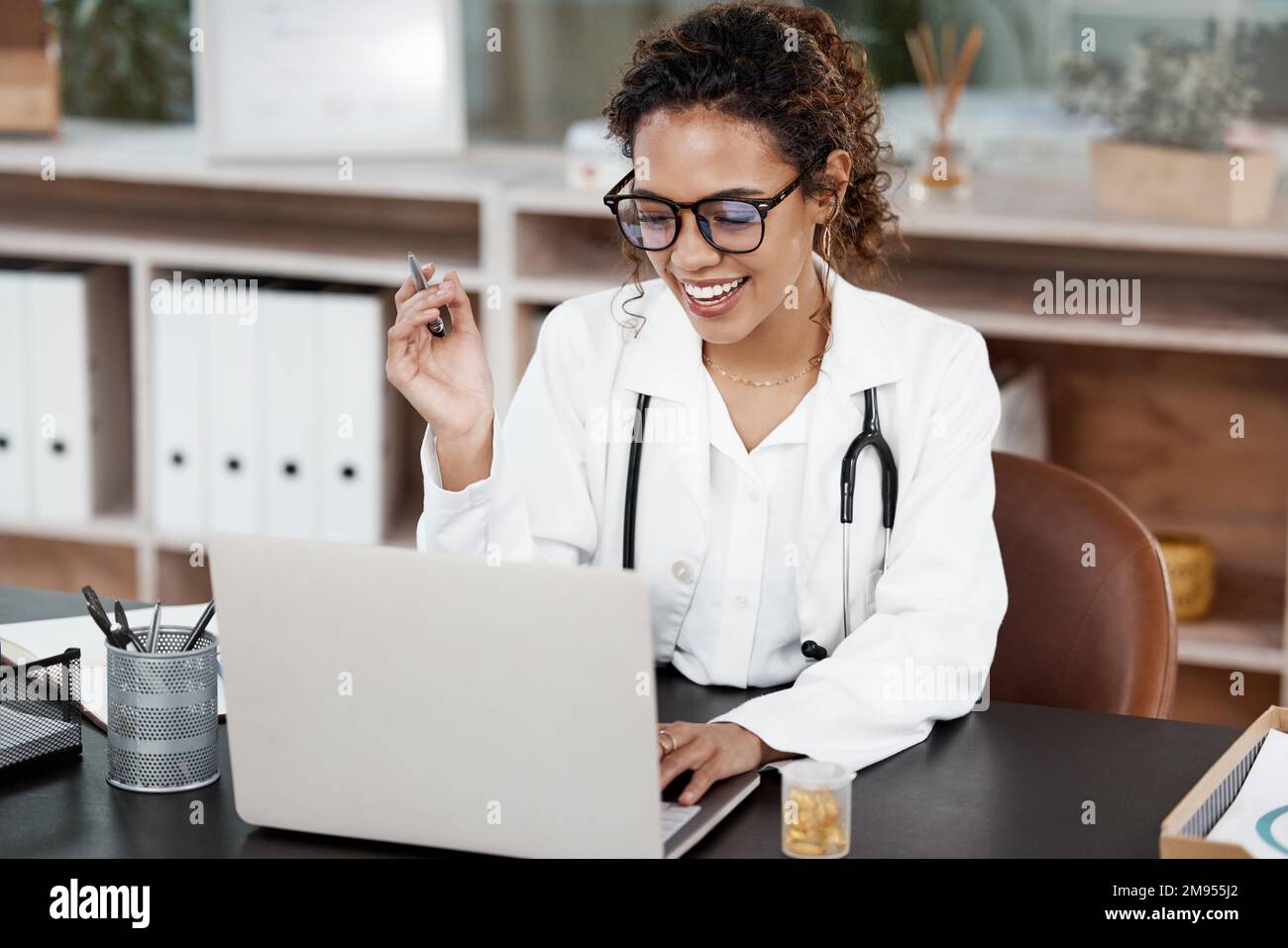 Seeing patients remotely. an attractive young female doctor working at ...