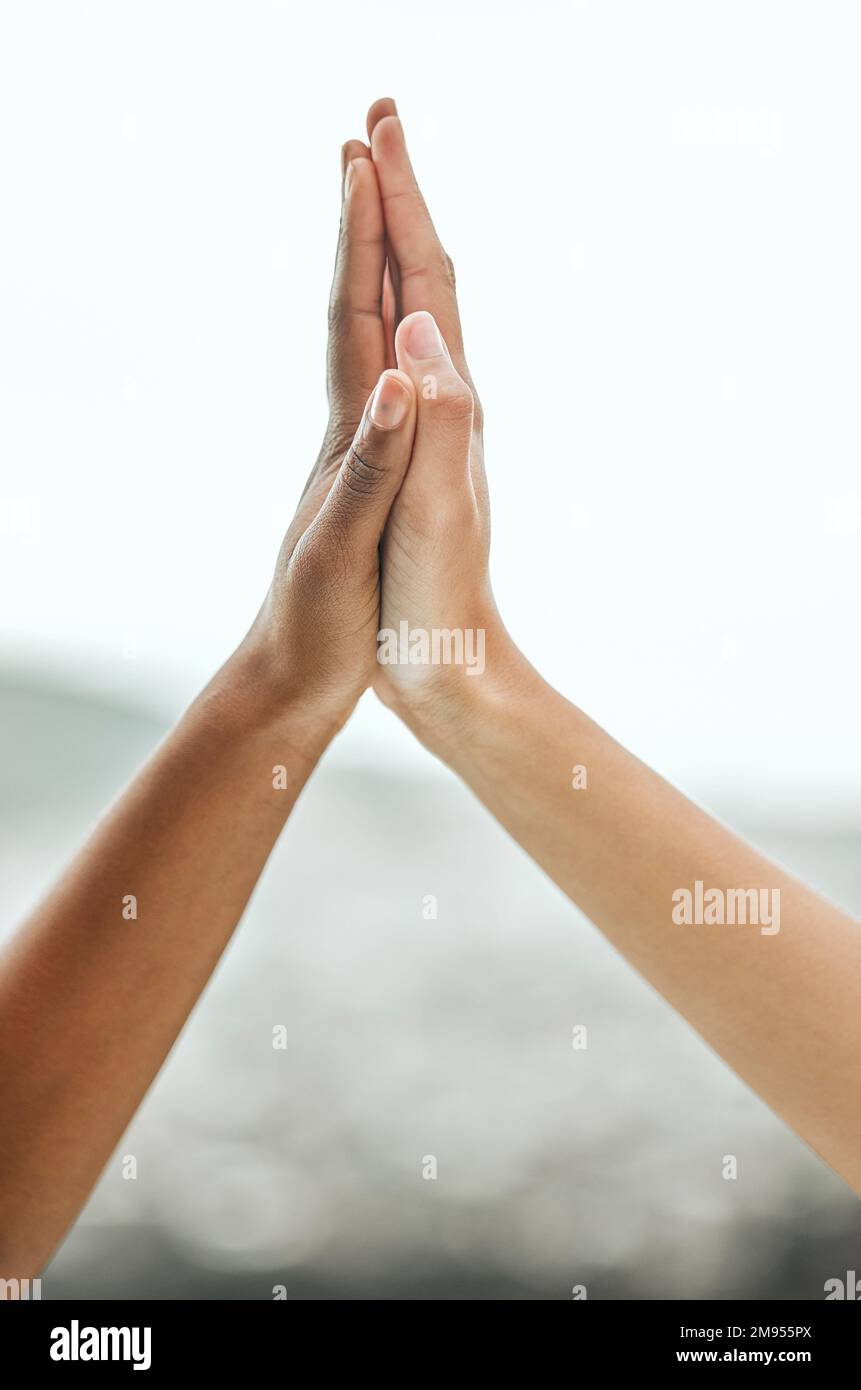 Pushing each other to do our best. two friends high fiving during a ...