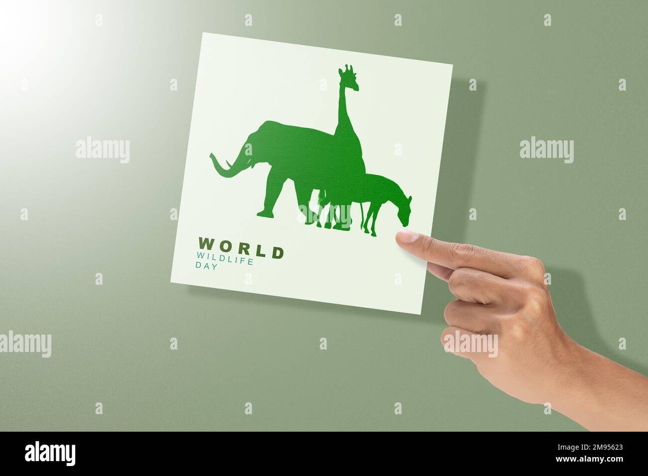 Human hand showing paper with World Wildlife Day message. World ...