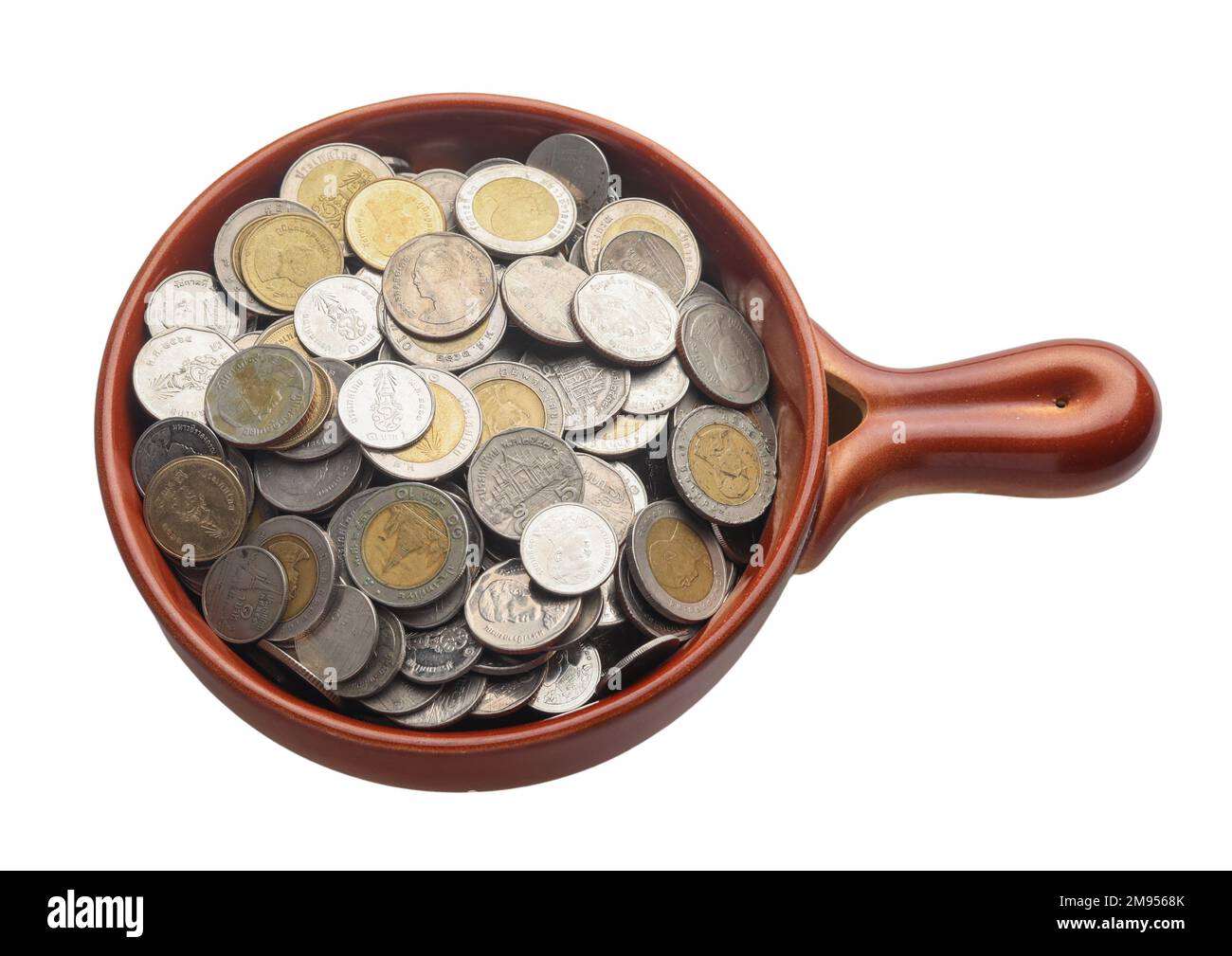 Coins in a ceramic cup on a white background Stock Photo - Alamy