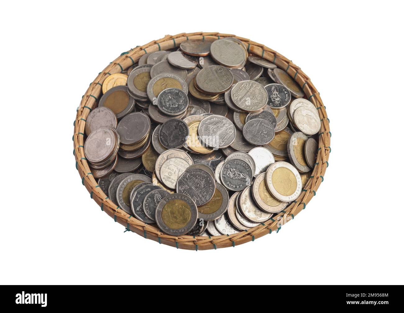 Coins in a bamboo basket on a white background.Saving money concept ...