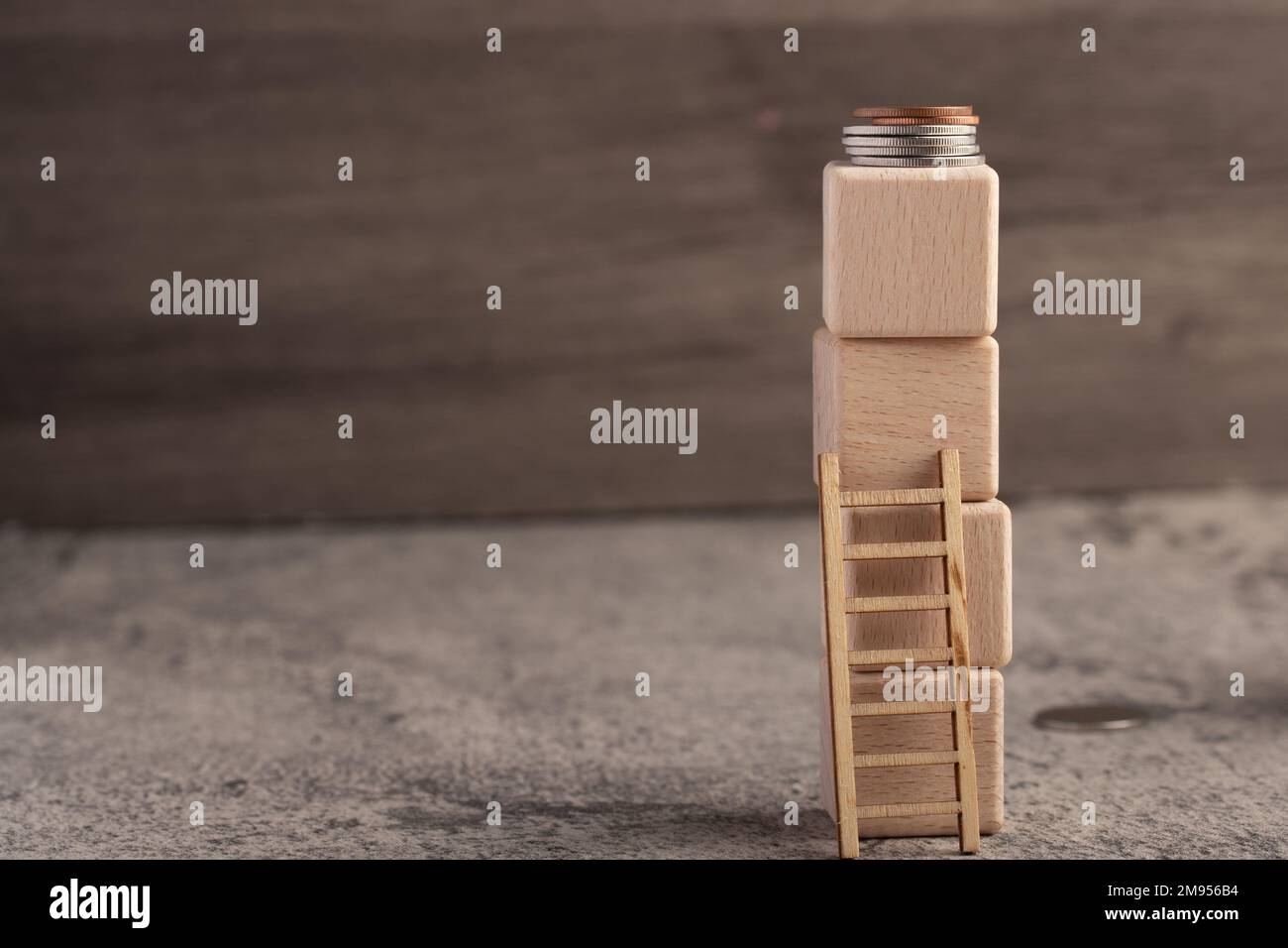 Stacked wooden blocks above as money. Gun up concept to earn money.Copy ...