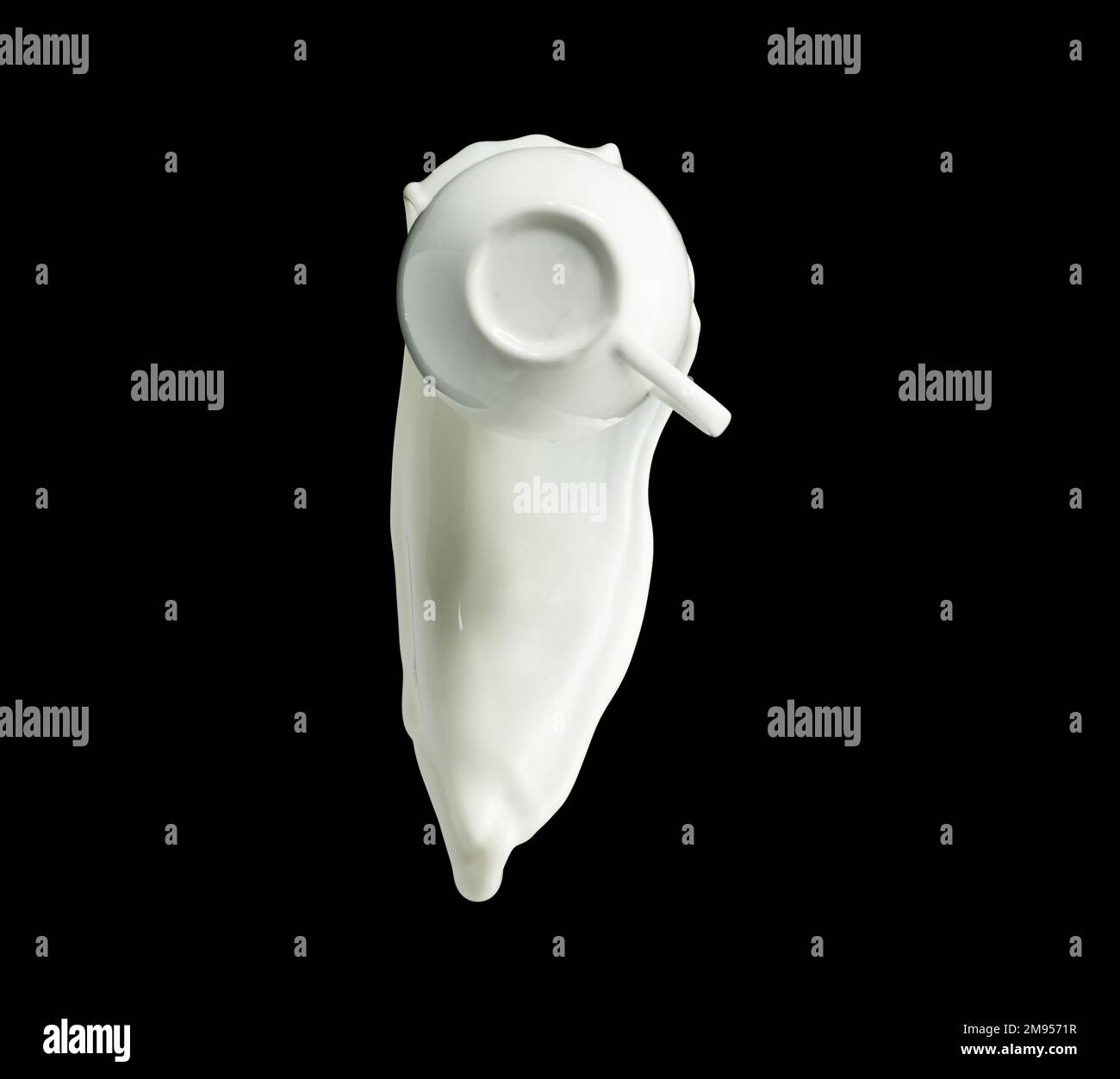 Milk splashing out of cup isolated on black background Stock Photo - Alamy