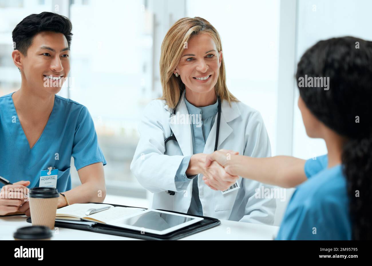 Two doctors shaking hands in a hospital hi-res stock photography and ...
