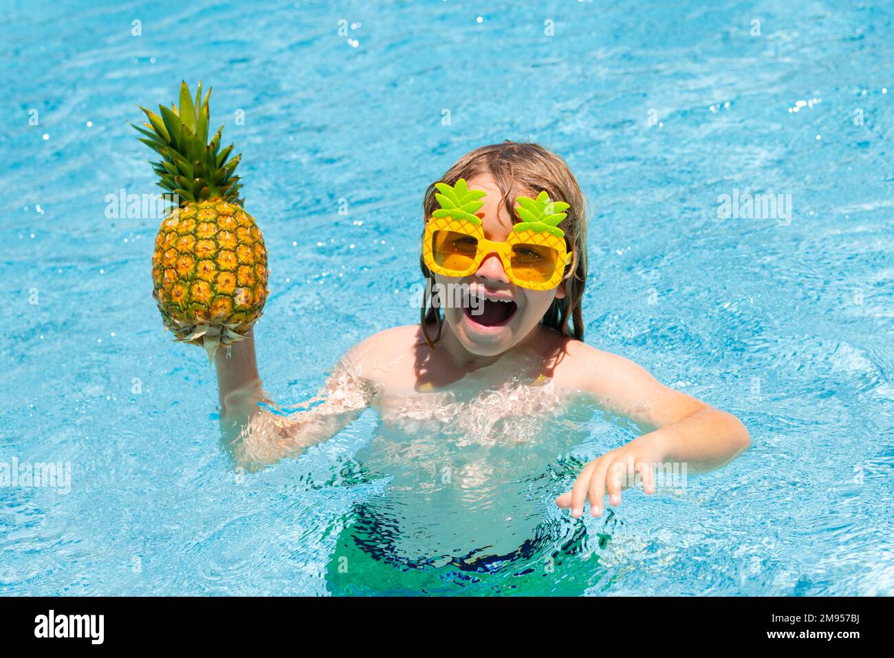 Summer vacation. Cute kid in swimming pool. Children play in tropical ...