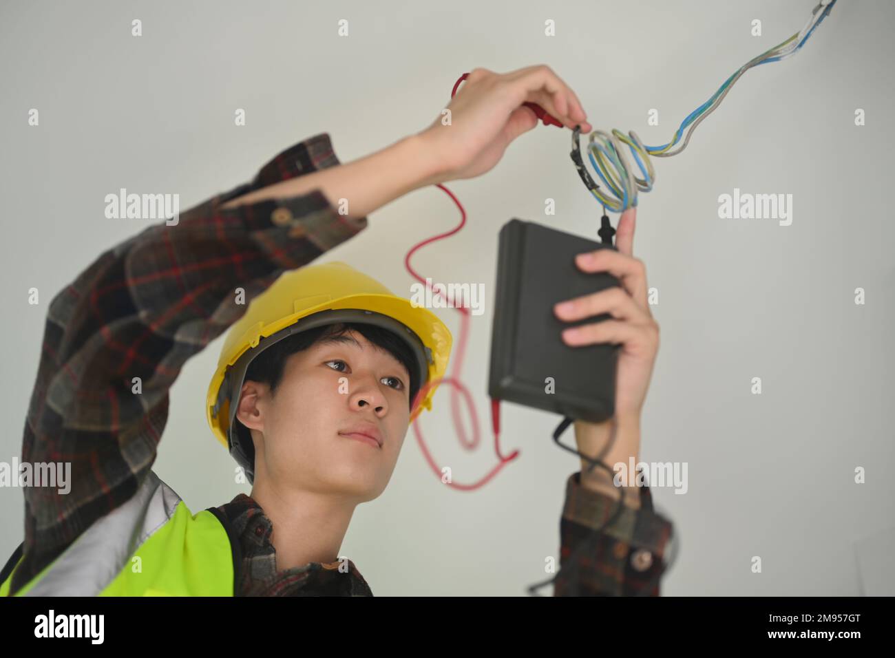 Electrician man working with cable mounting and assembling new wiring ...