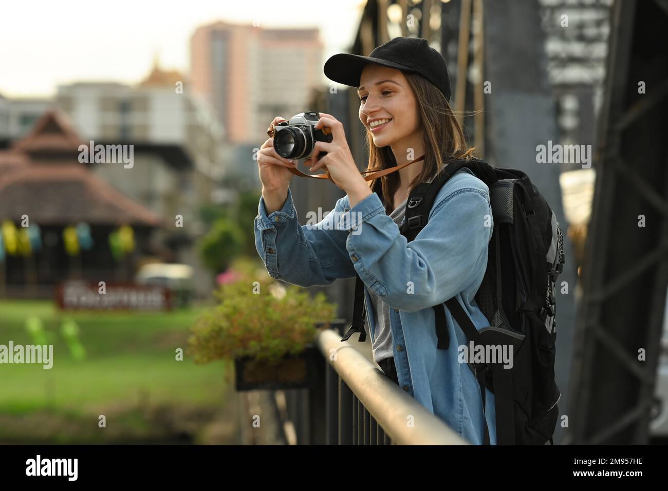 Cheerful female travel blogger recording video vlog with camera while ...