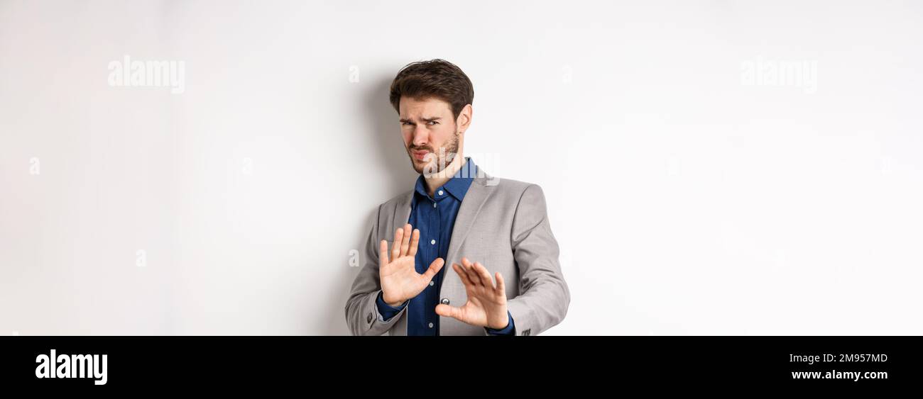 Stay away. Reluctant businessman step back with concerned disgusted ...