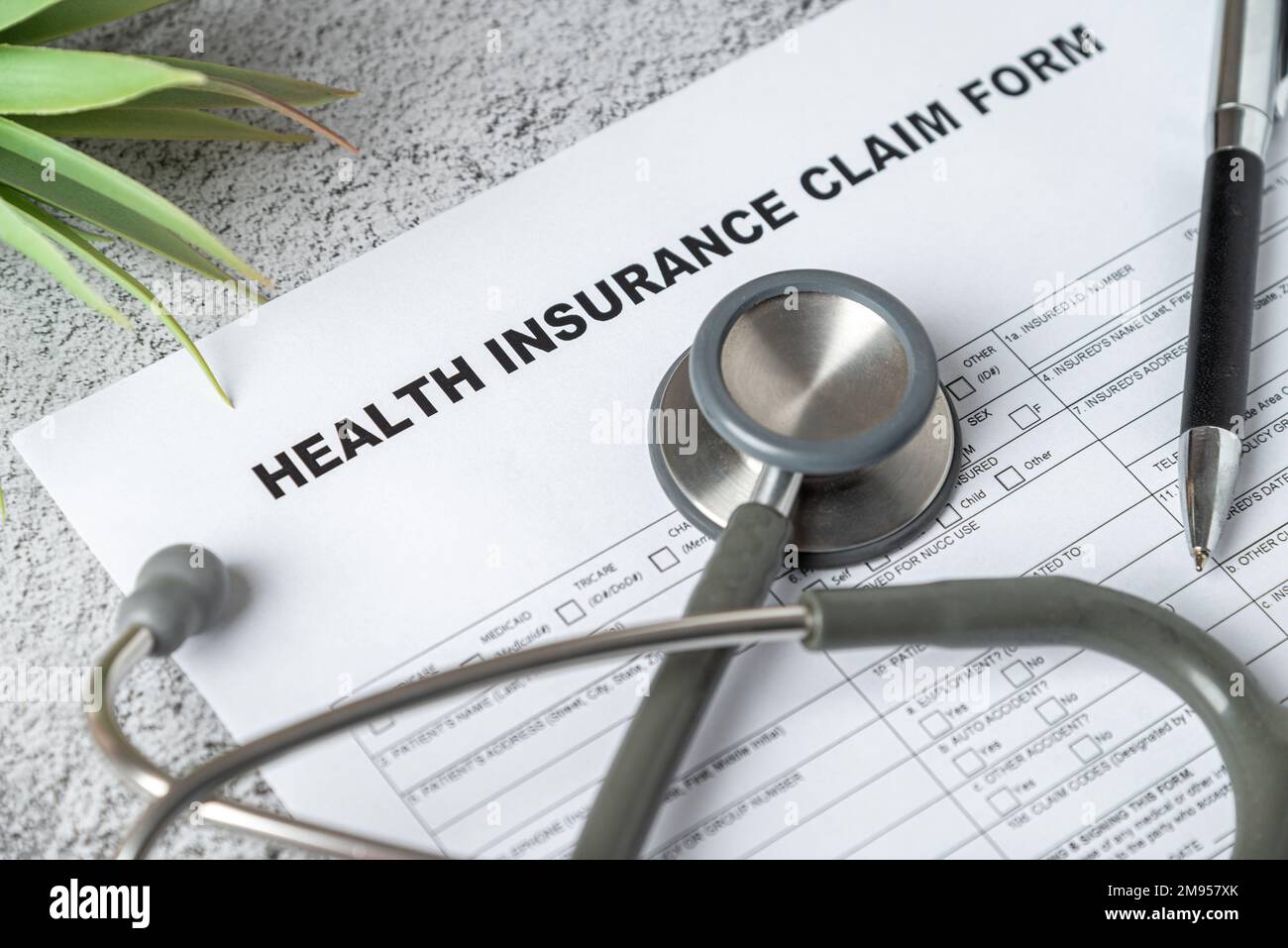 Top view of doctor stethoscope, pen and health insurance claim form on ...