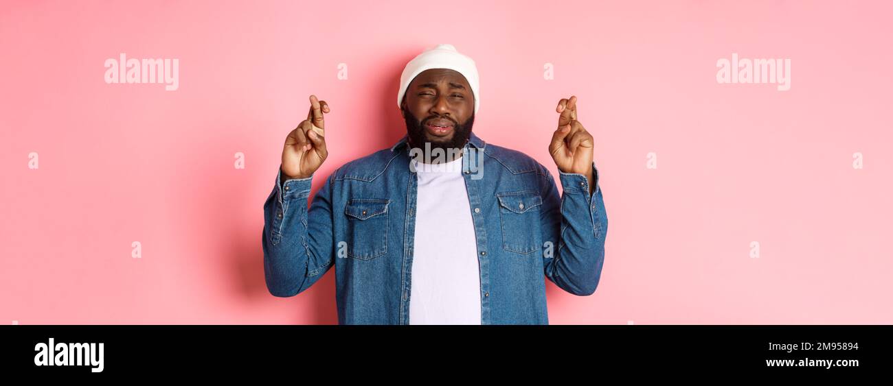 Image of young african-american man whining, pleading god, cross ...