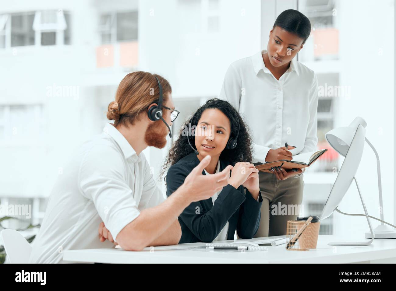 Time for training. two young call center agent and their supervisor ...