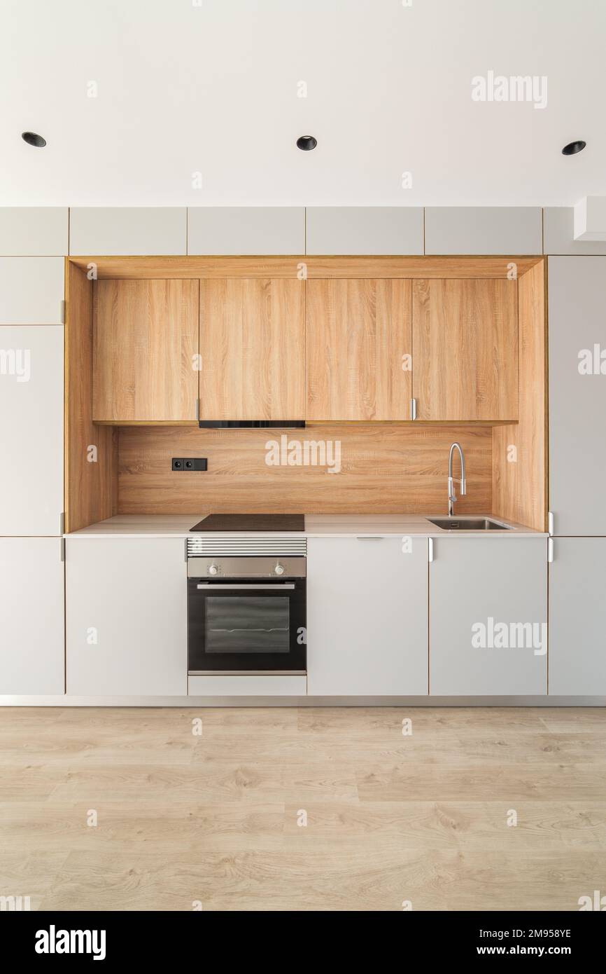 Simple empty modular kitchen area in modern apartment. Furniture ...