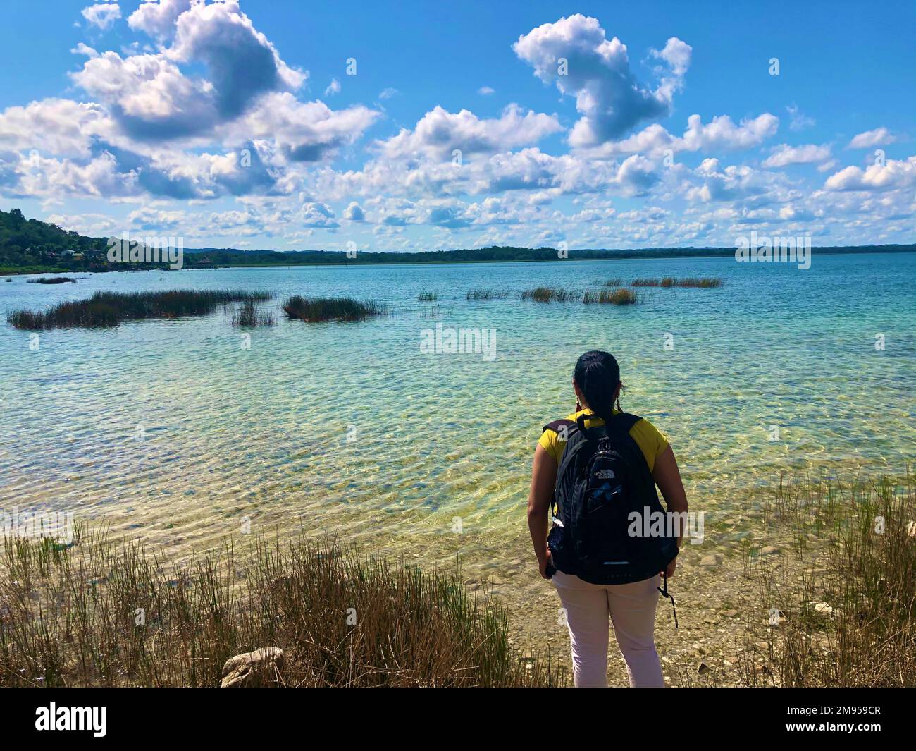 Female tourist looking at Lake Izabal, El Remate, Peten, Guatemala ...