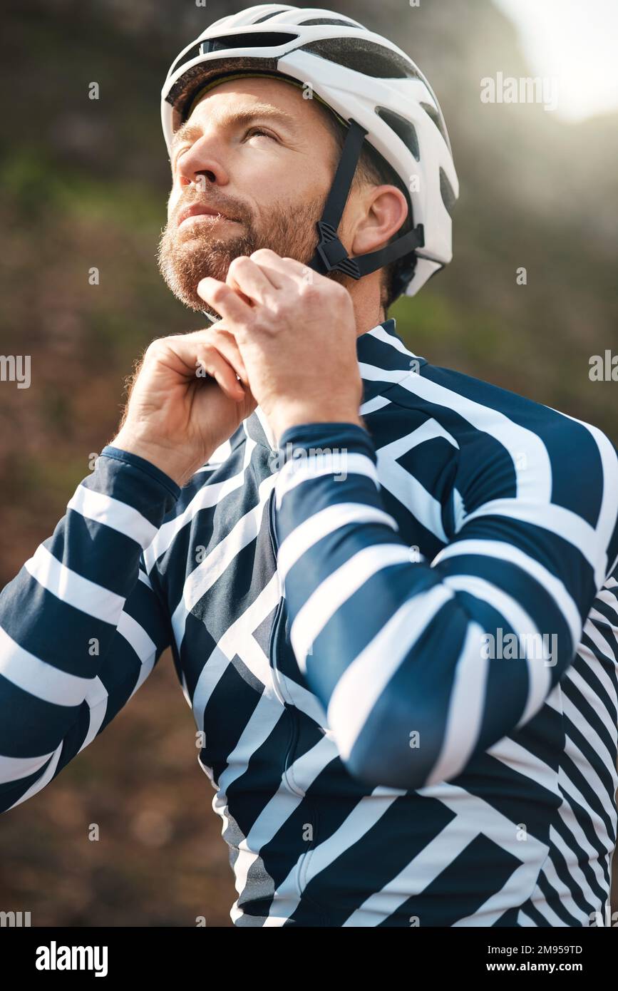 Every cyclist knows the importance of a helmet. a handsome mature man ...