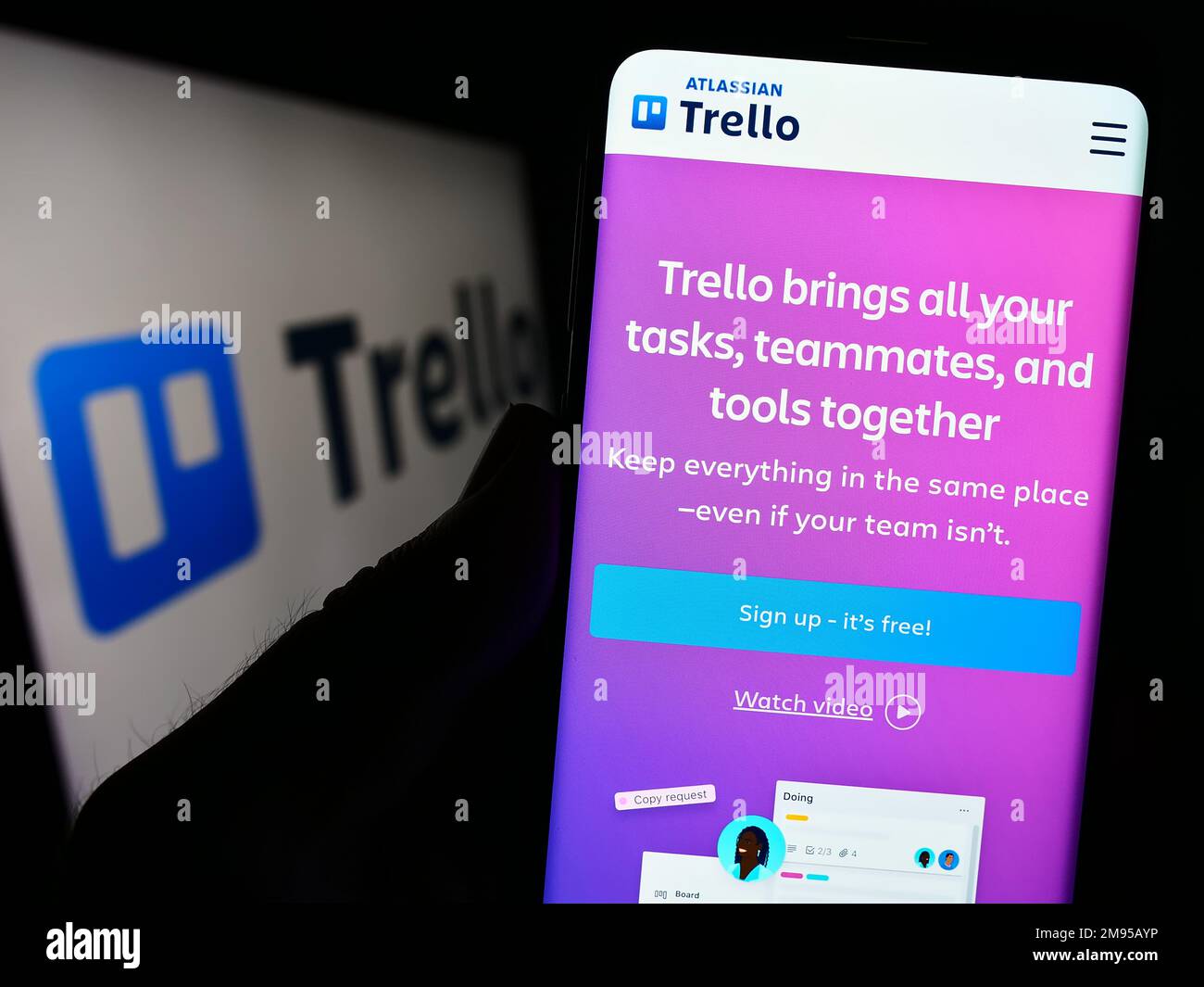 Person holding cellphone with website of list-making software Trello on ...