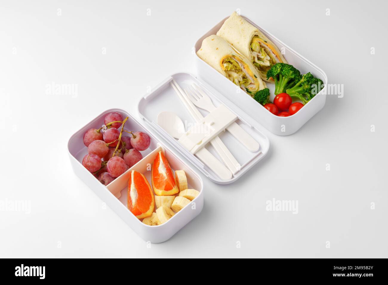 Lunch boxes with healthy food isolated on white Stock Photo - Alamy