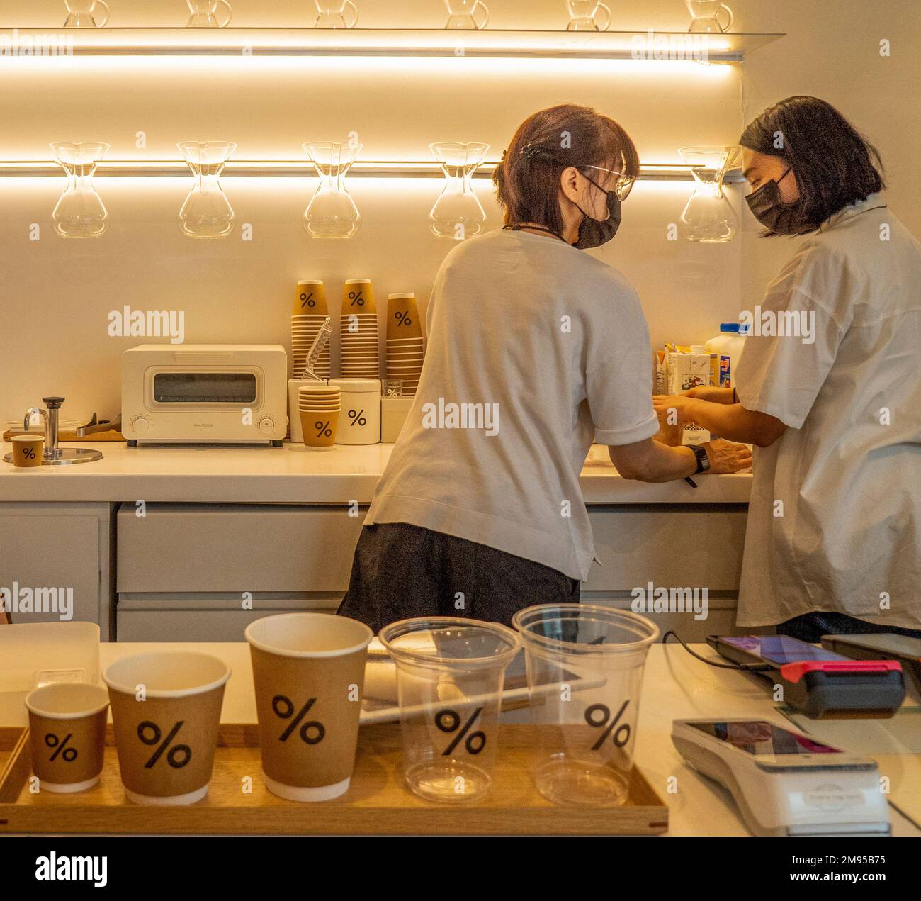% Arabica Coffeeshop Arab Street baristas wearing face mask Stock Photo ...