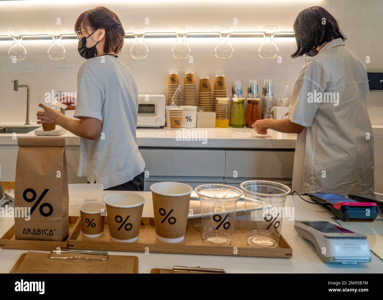 % Arabica Coffeeshop Arab Street baristas wearing face mask Stock Photo ...