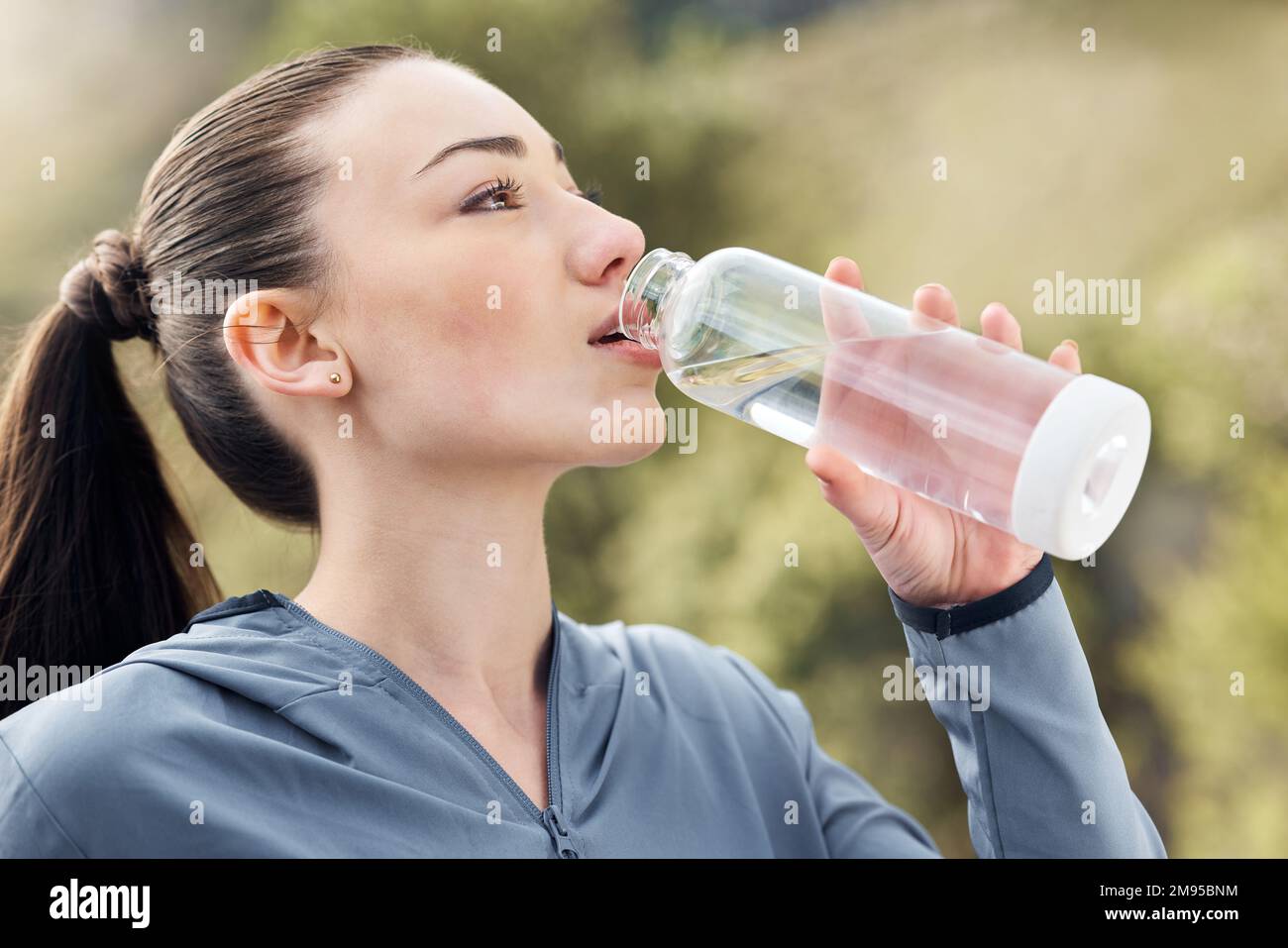 I just need some water now. a woman drinking water while out for a ...