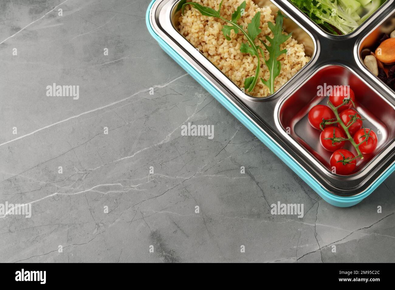 Lunch box with ready food on gray background Stock Photo - Alamy