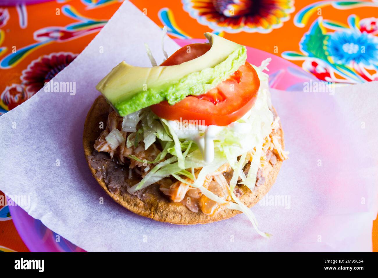 Tostada with salad and avocado. Tostada, name given to various dishes ...