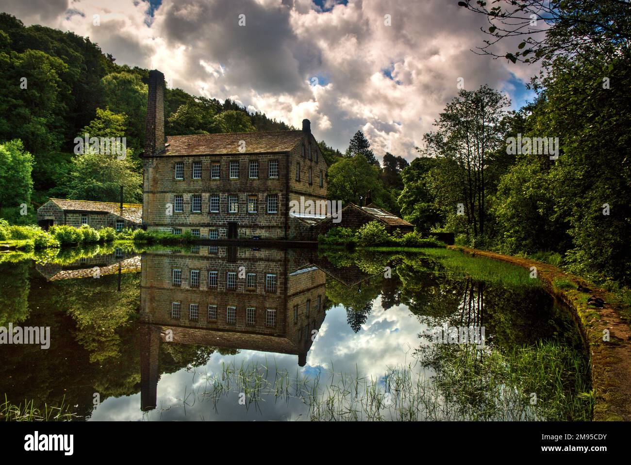A landscape of Gibson Mill Museum by reflecting river in England with ...